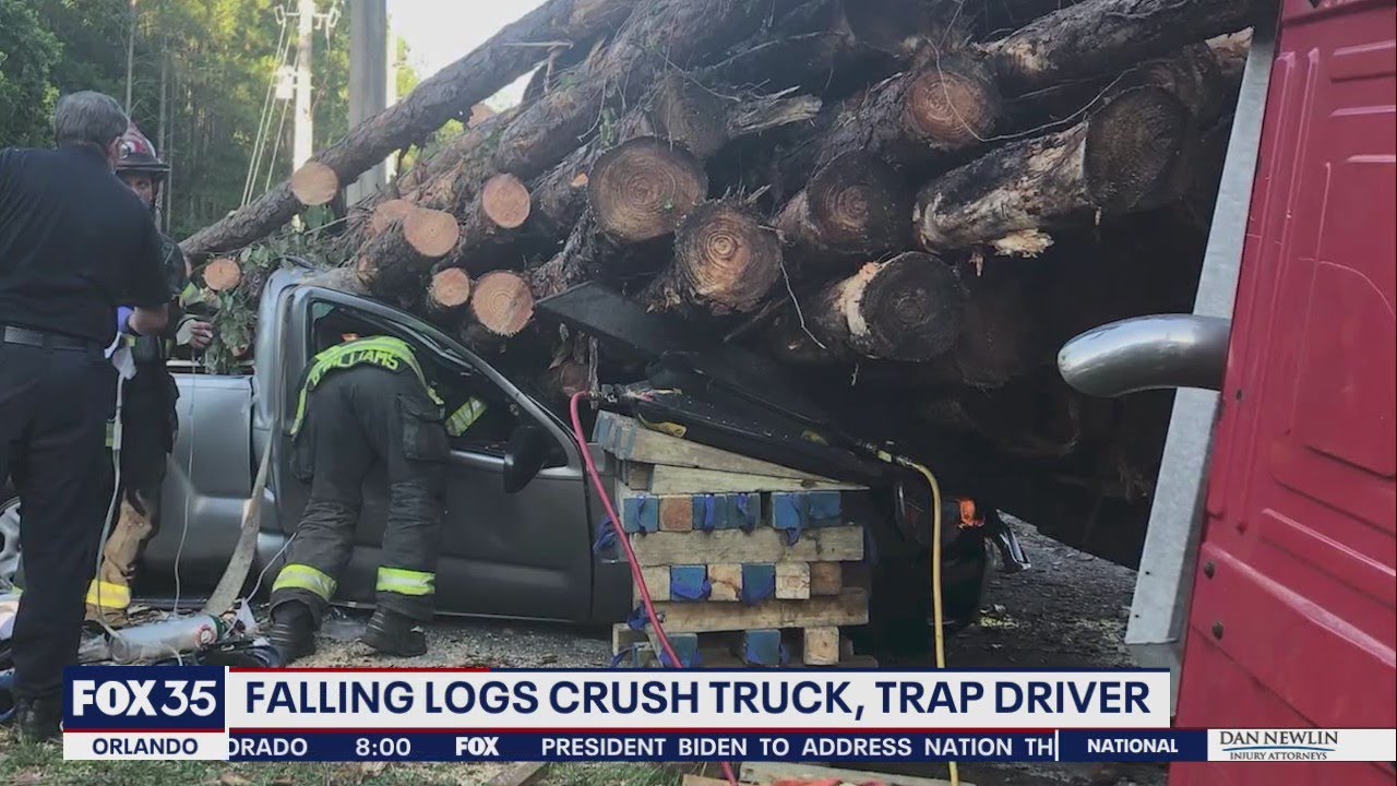 Florida man rescued after log hauler flips, falls on his truck - YouTube