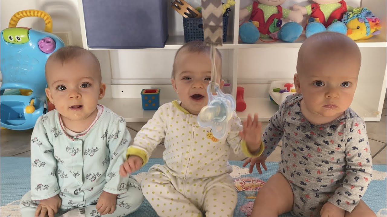 Adorable and funny triplet babies playing and fighting over pacifier ...