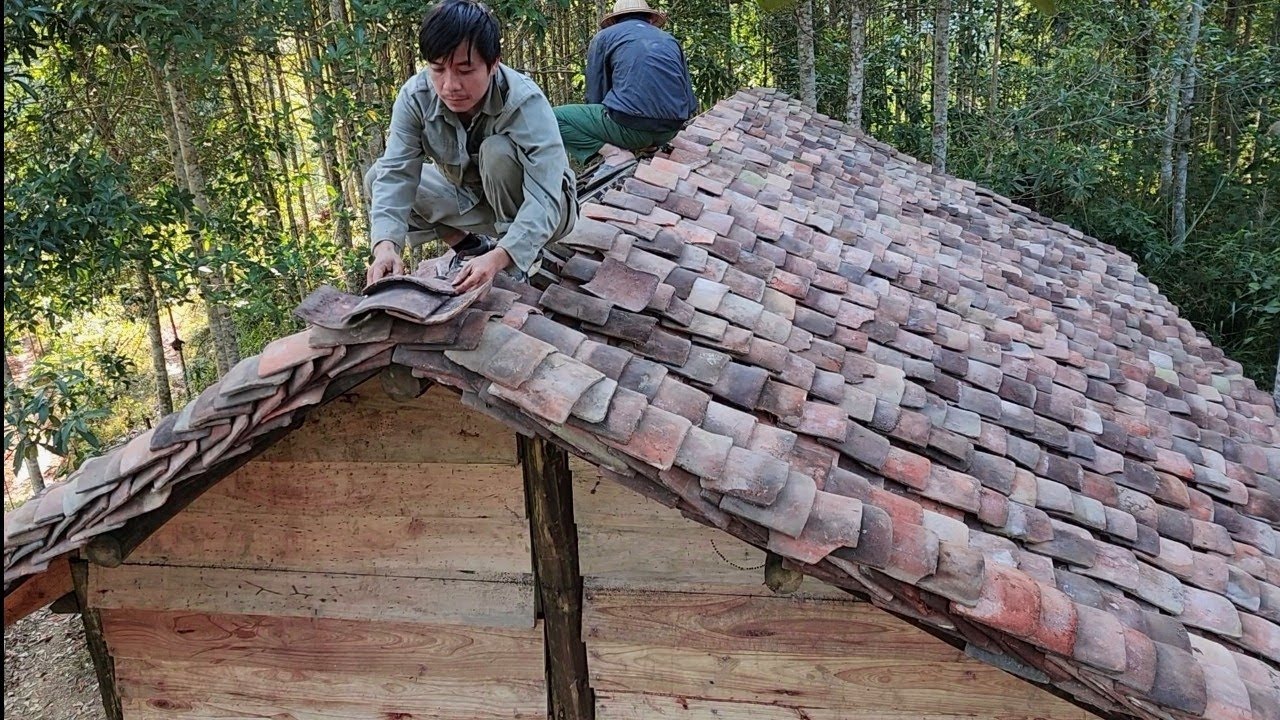Together we built a wooden house (cabin) with an ancient tile roof ...