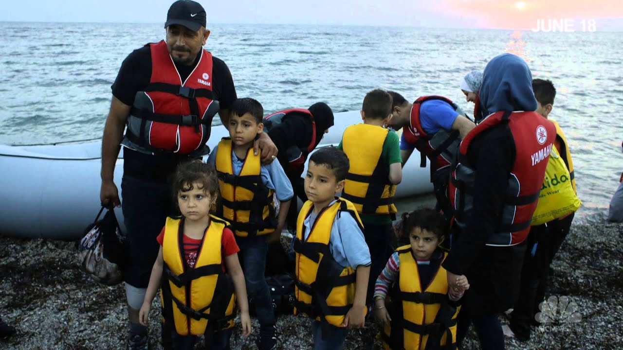 Syrian Refugees Come Ashore In Greece As Beachgoers Watch | Short Take ...