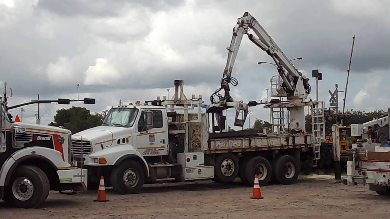 Loading rail ties onto a Sterling HiRailer flatbed - YouTube