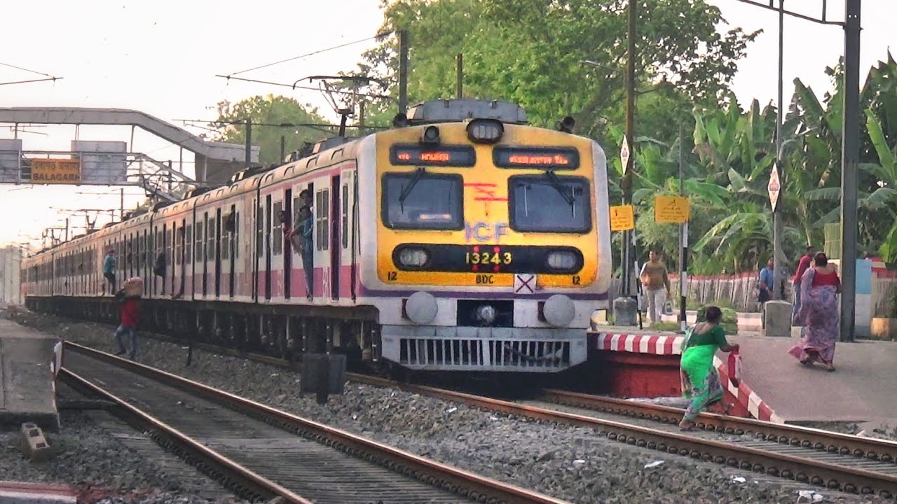 Ladies passengers are running to board the crowded EMU local train ...