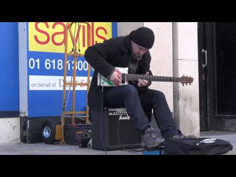 Amazing street player with a castrol guitar