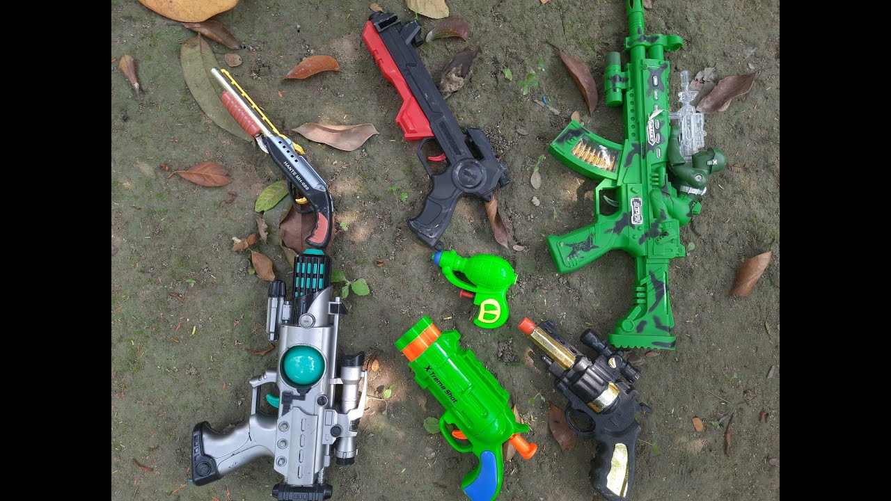 Lots of Guns & Equipment on the dirty field, Super Hero Action Series ...
