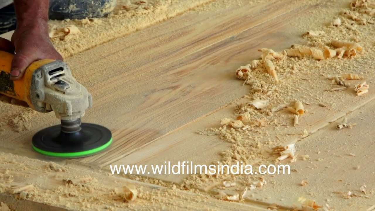 Wood smoothening: machine works on finishing a wooden flooring in a ...