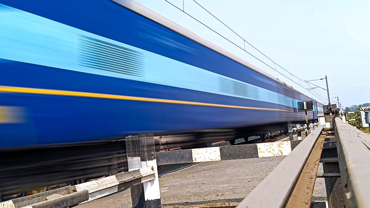 High speed Automobile carrier train furiously crossing railroad - YouTube