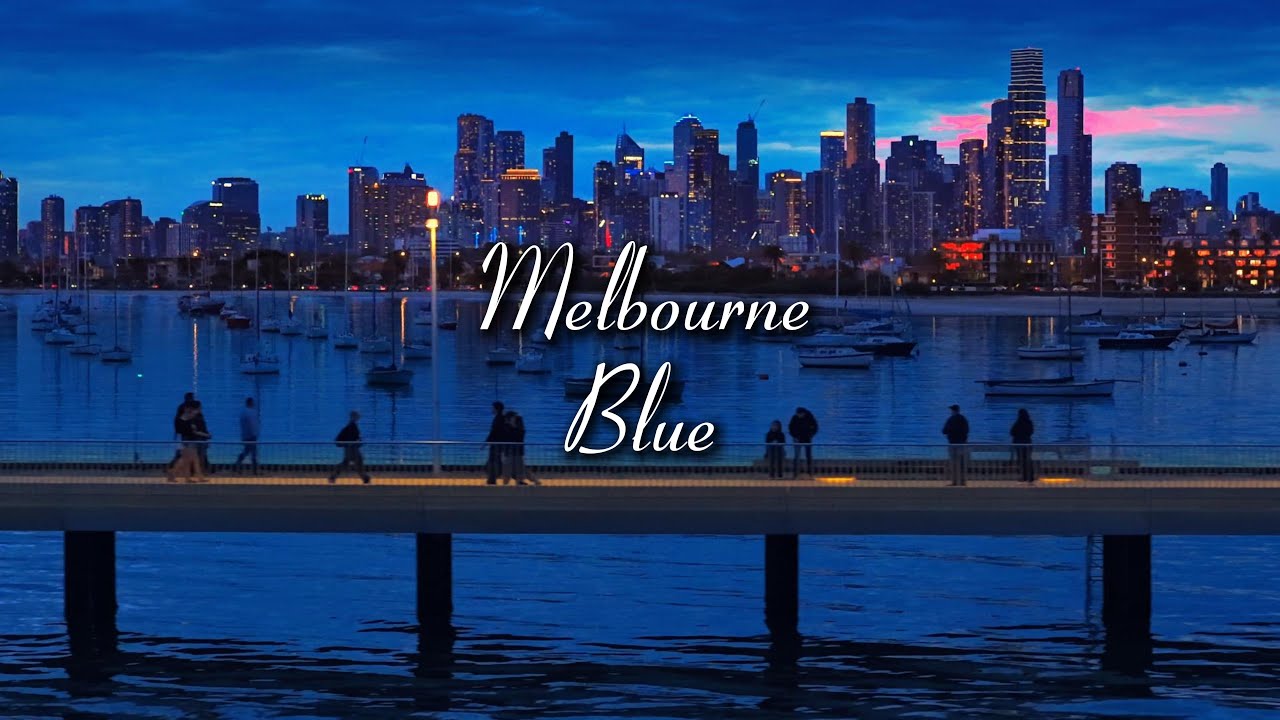 Blue hour over St Kilda Pier with the Melbourne skyline shimmering ...