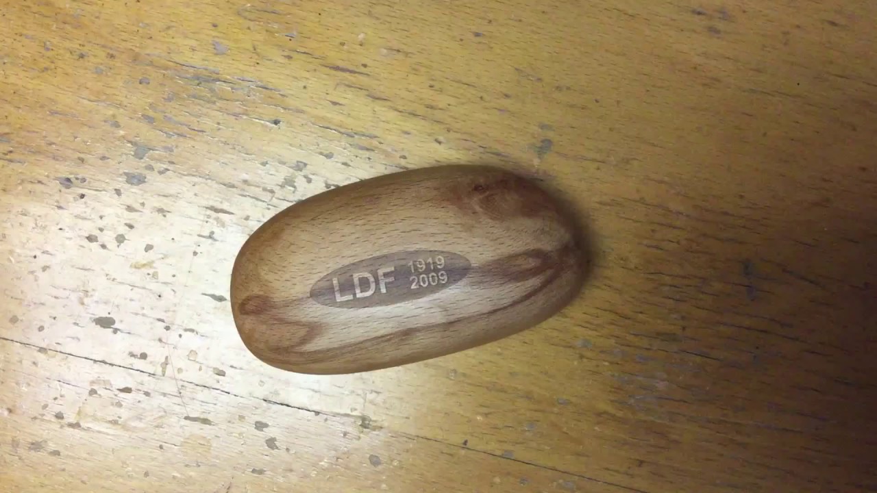 Wooden stone as a rattleback - YouTube