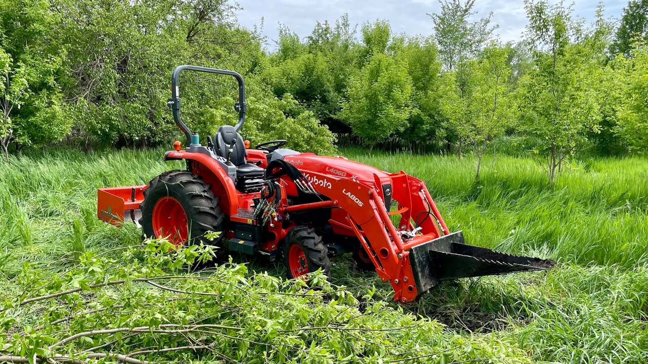 Digging out trees with the Kubota - YouTube