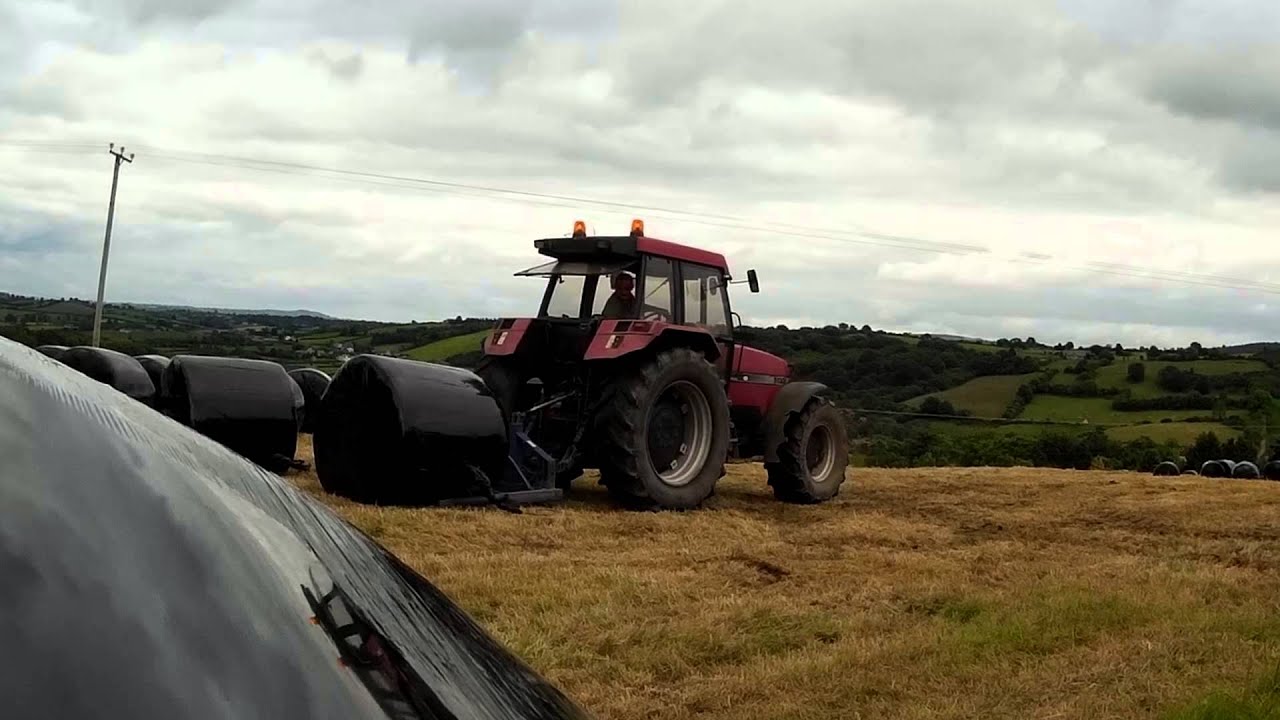 Stacking round bales with Case Maxxum 5130 - YouTube