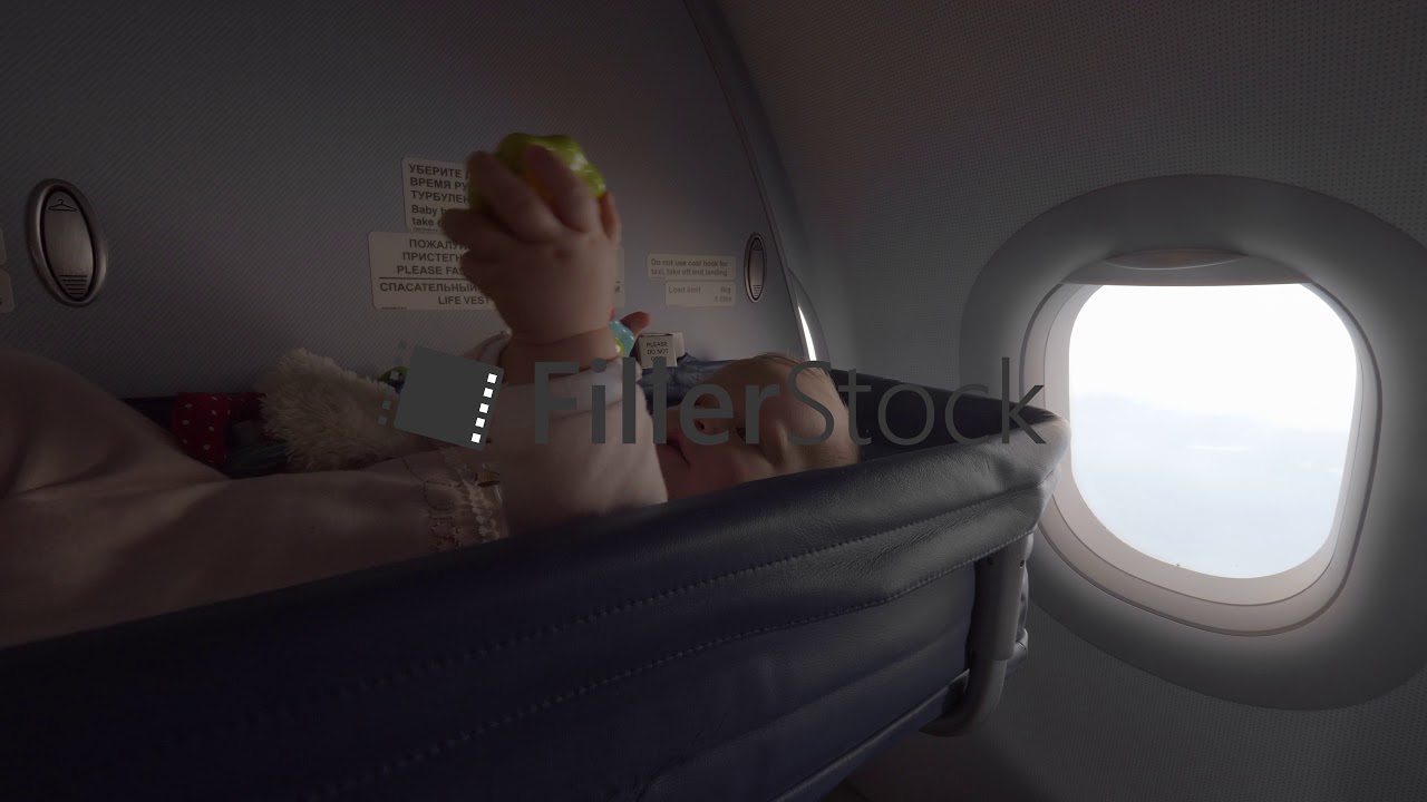 Baby in a cot bassinet on an airplane - YouTube