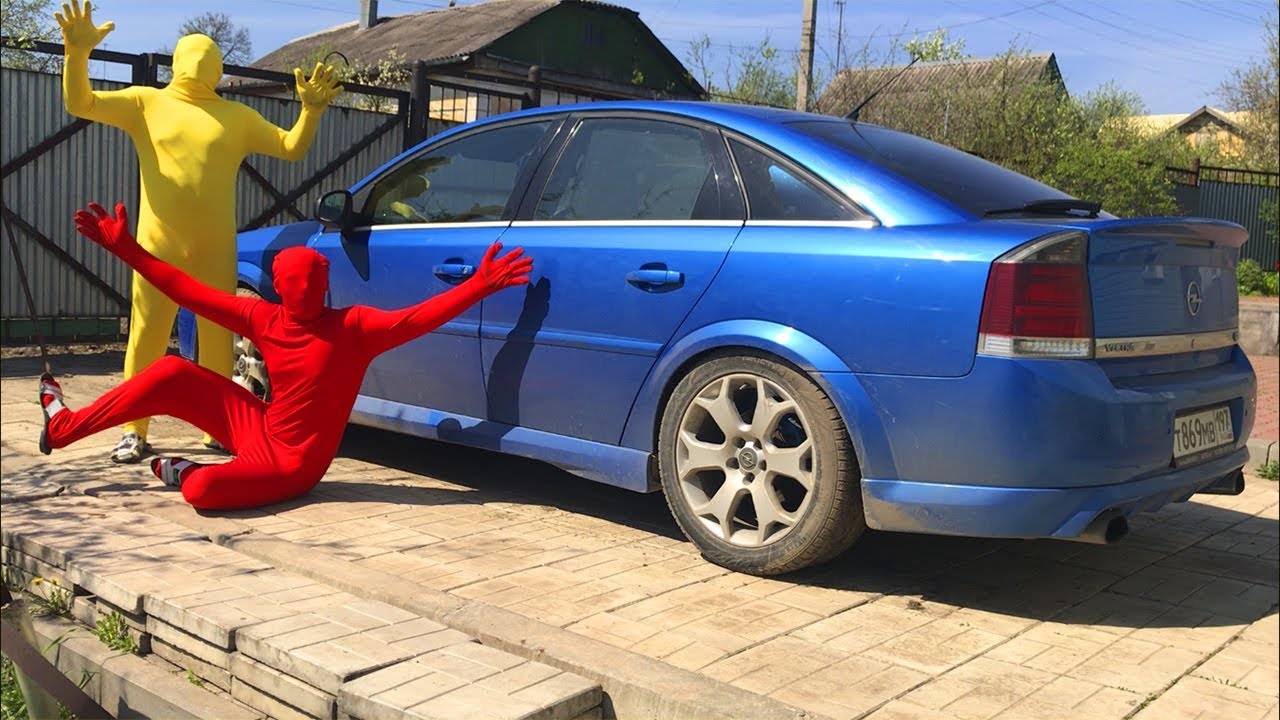 Yellow Man on Opel Vectra OPC & Red Man on Corvette in Car Service w ...
