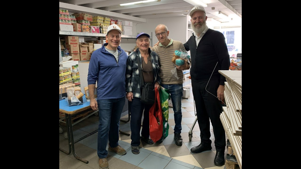 Mr. Oliver Stanton joins in preparing and delivering food packages for ...