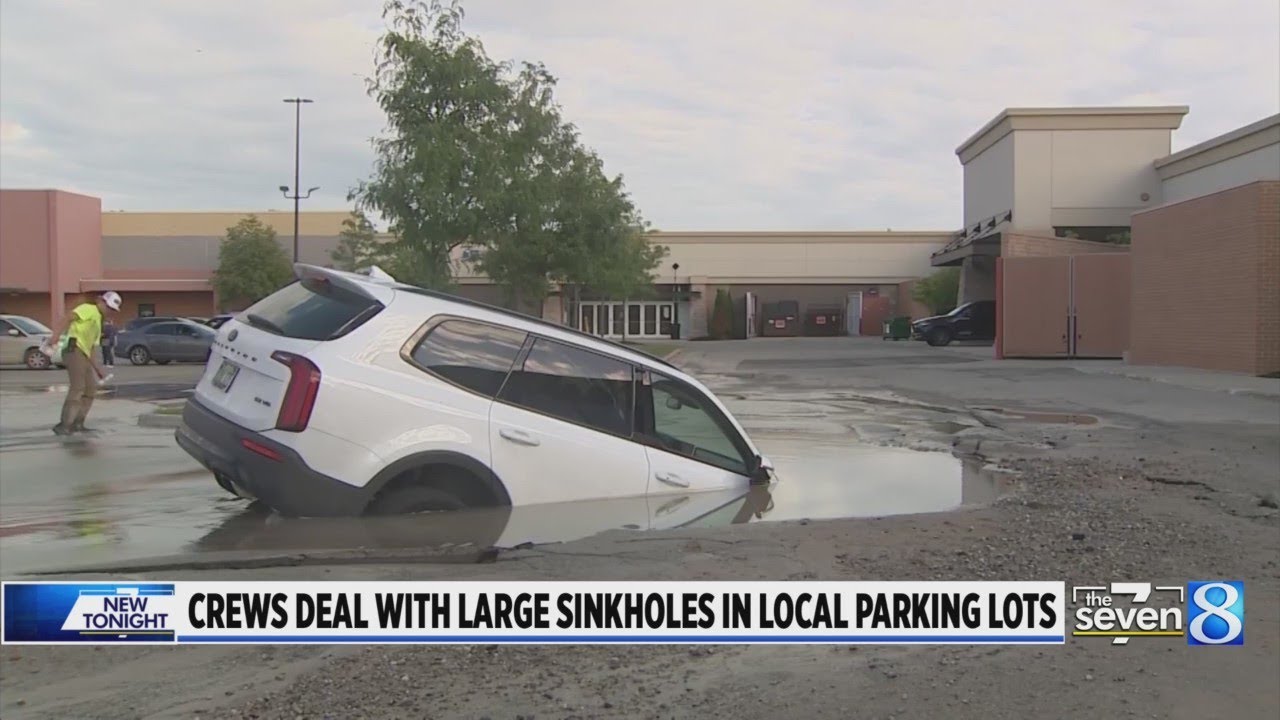 Sinkholes creating parking lot problems along 28th Street - YouTube
