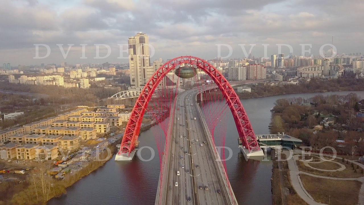 Metal construction of red arch cable stayed Picturesque bridge over ...