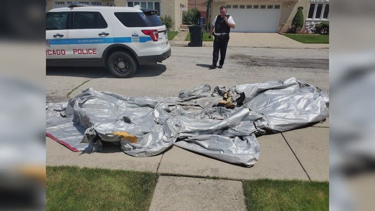 Airplane's emergency slide falls into Chicago backyard - YouTube