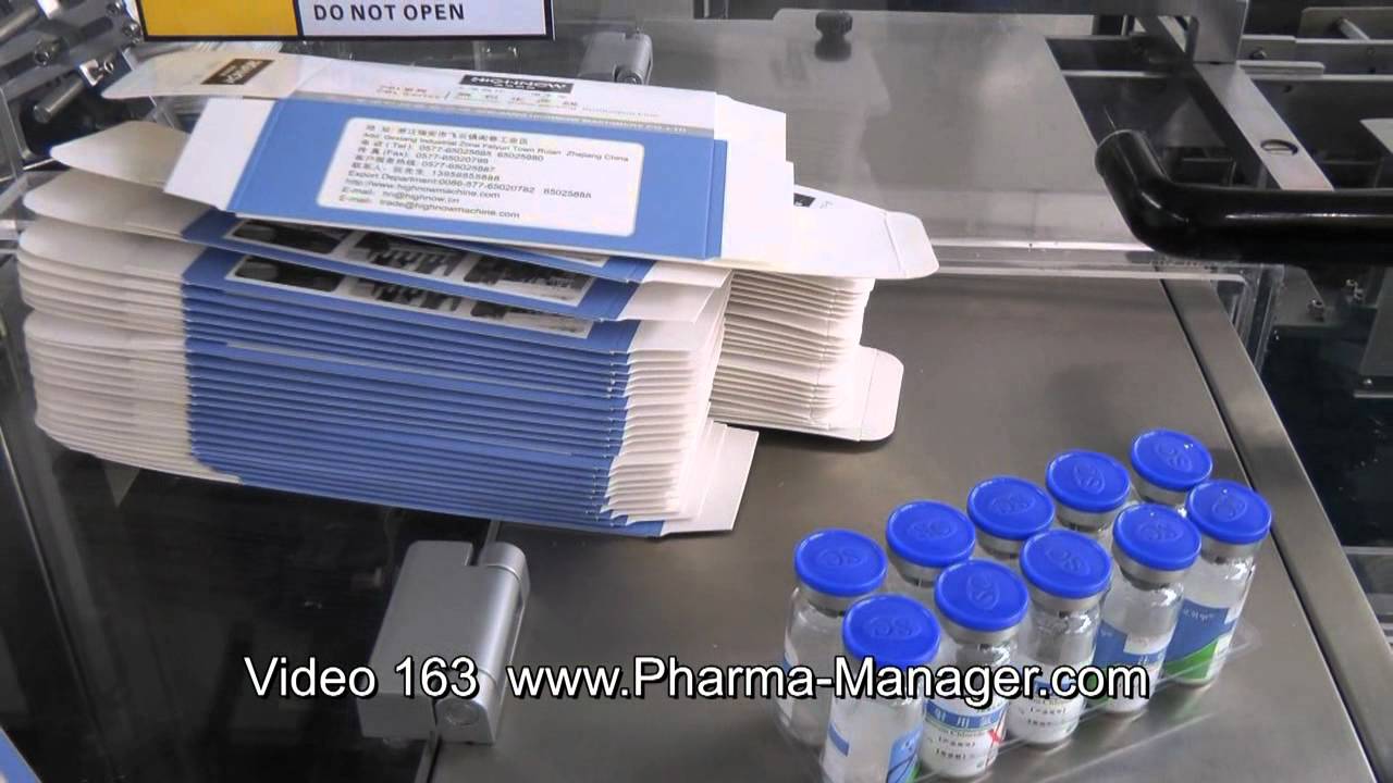 Cartoning Machine for packing of penicillinic vials in cardboard. Video ...