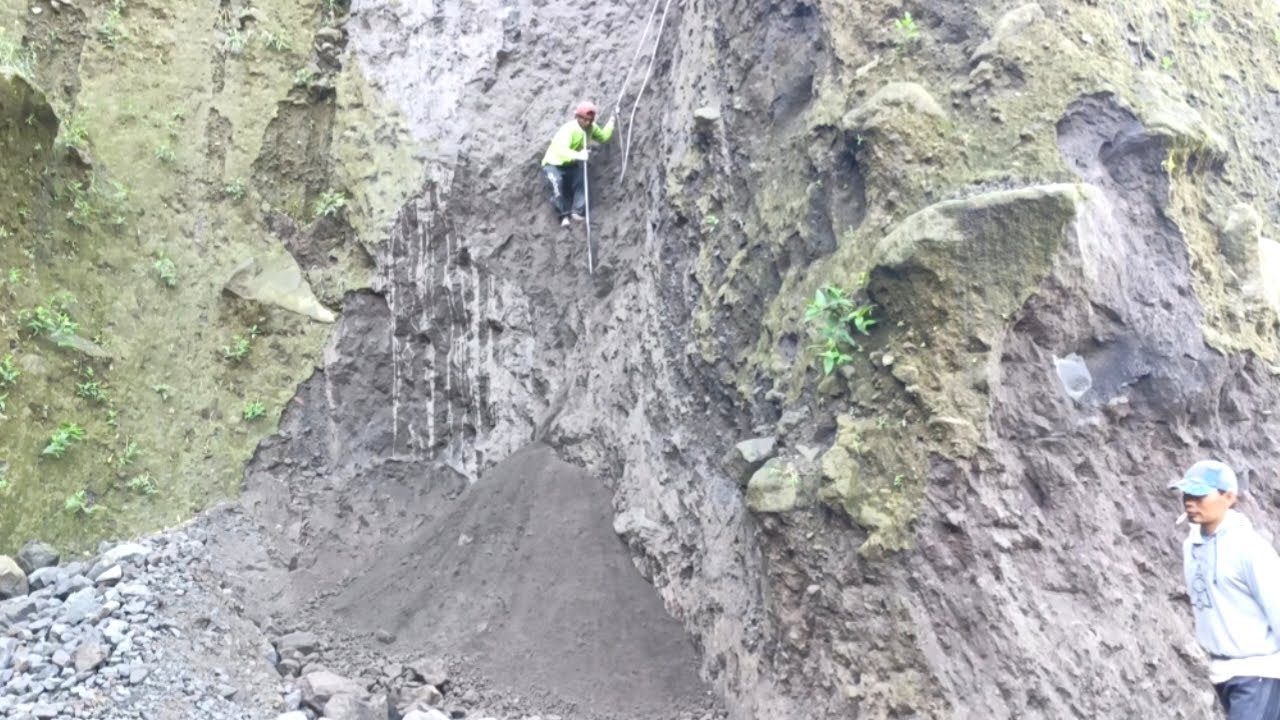 The process of eroding super black sand from cliffs and miners directly ...