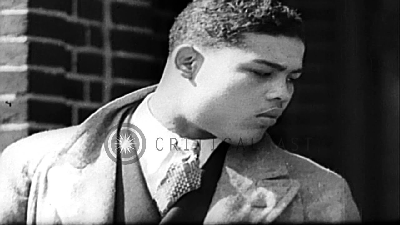 Boxer Joe Louis and his wife Mara Trotter are seen outside a building ...