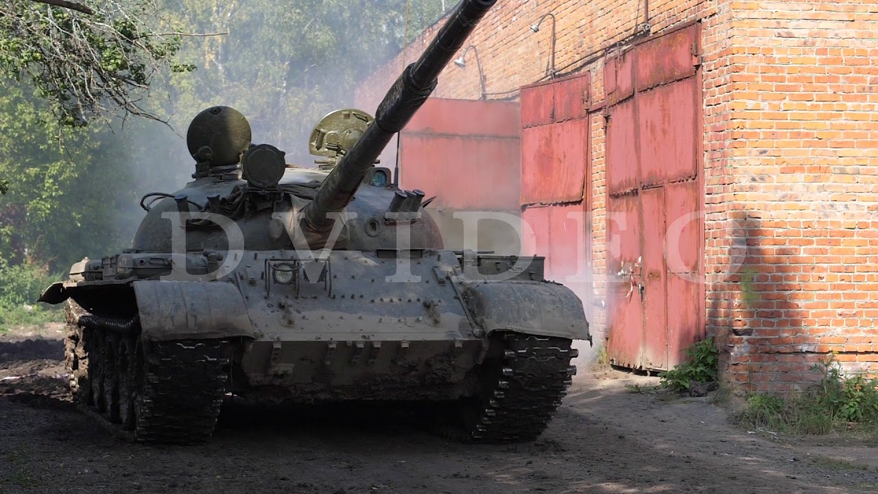 Military tank driving on road slow motion. War tank on bakground brick ...
