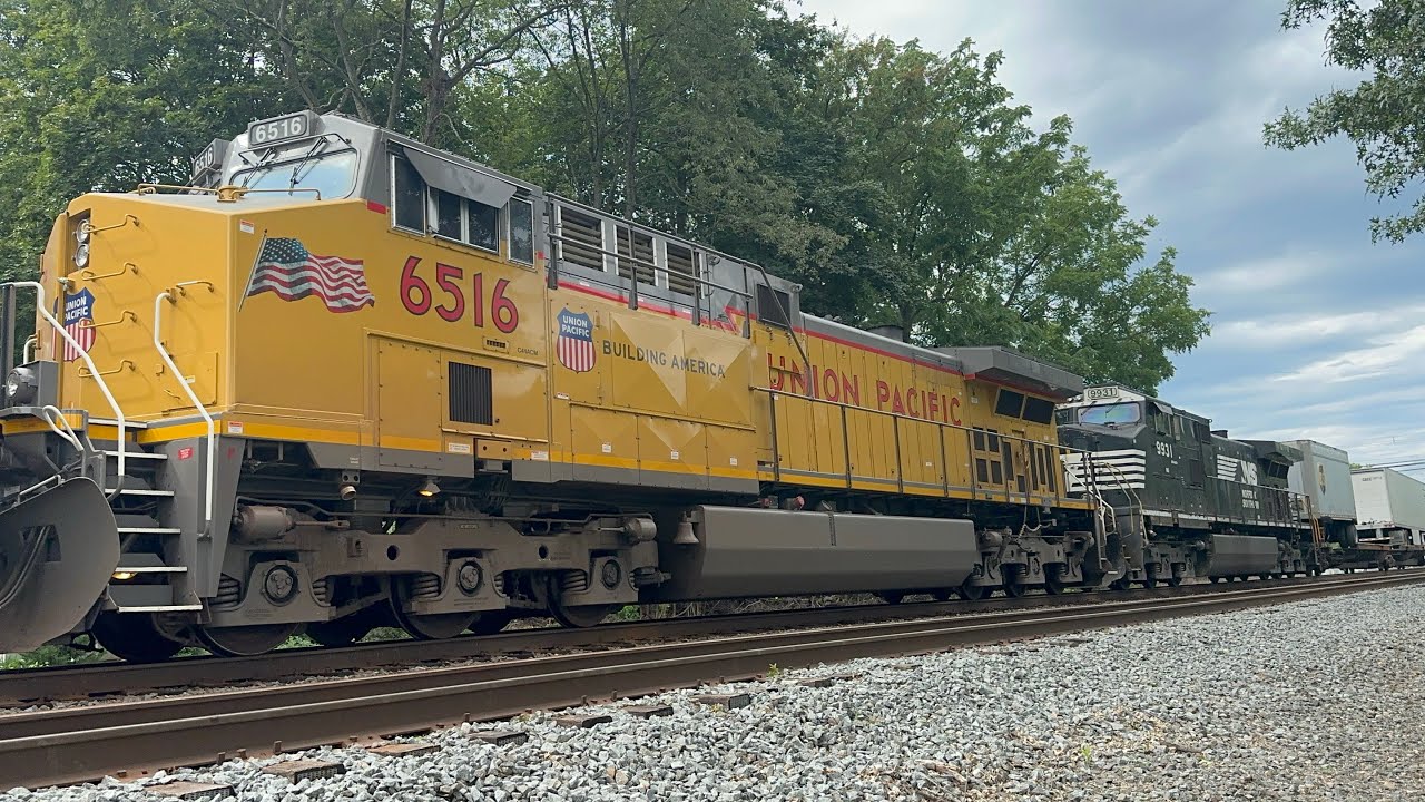 NS 7695 ES44AC leads NS 24X through Manville NJ with a newly painted UP ...