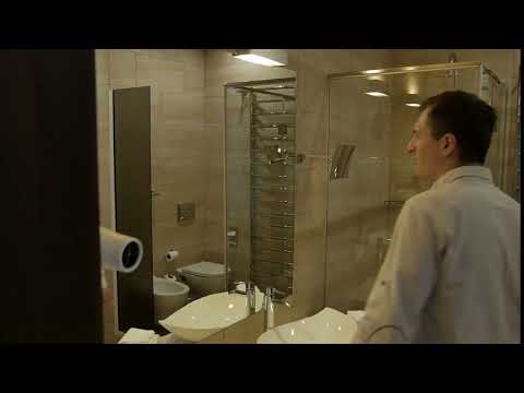 a young man walks into the bathroom b