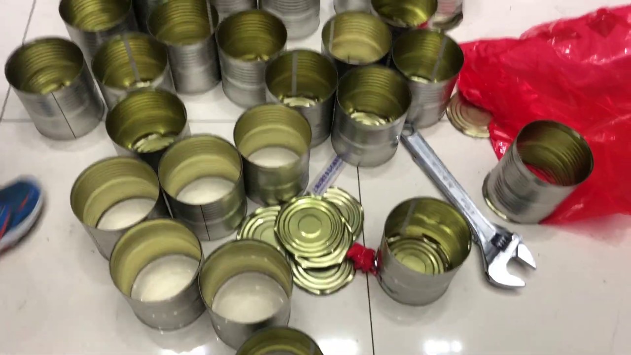 Commerical can opener: Show of openning consecutive dozens of cans ...