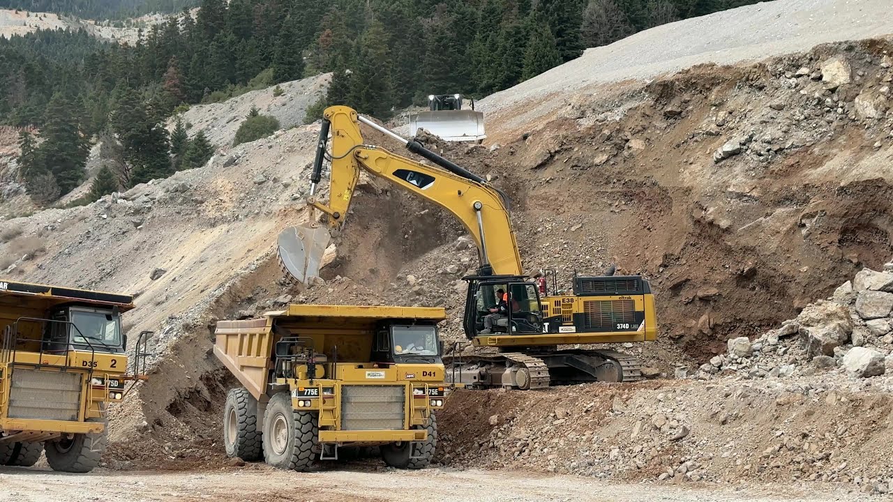 Caterpillar 374D Excavator Loading Caterpillar 775 Dumpers With Help ...