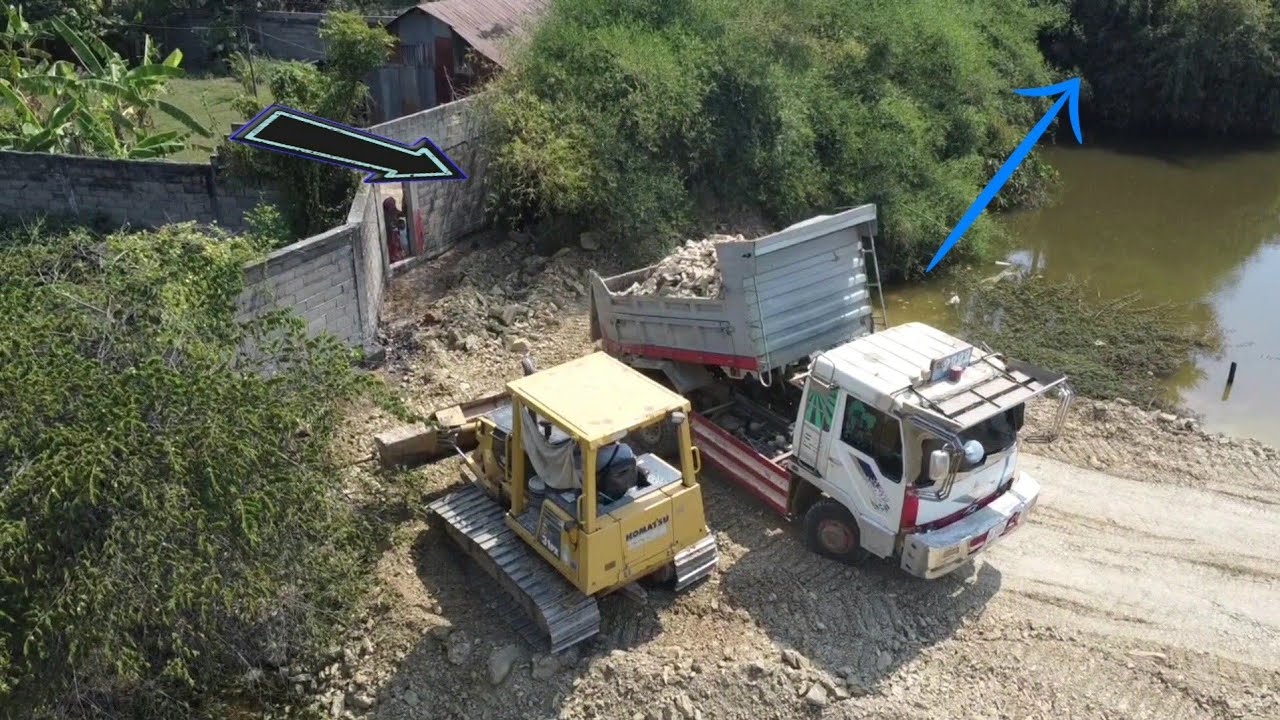 Bulldozer KOMATSU D31PX with Dump Truck Working Making Foundation Road ...