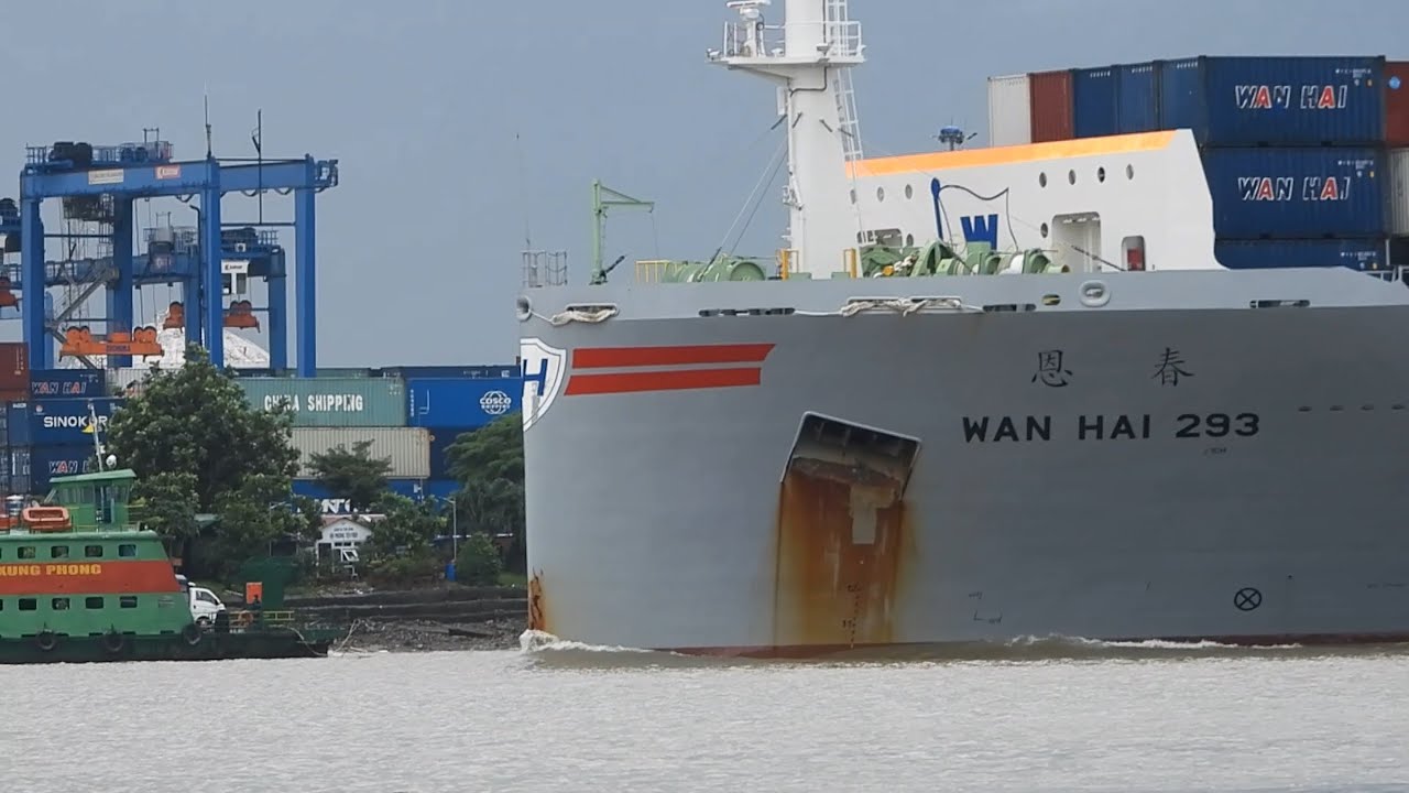 Watch the very large and long newly built cargo ship leave the port ...