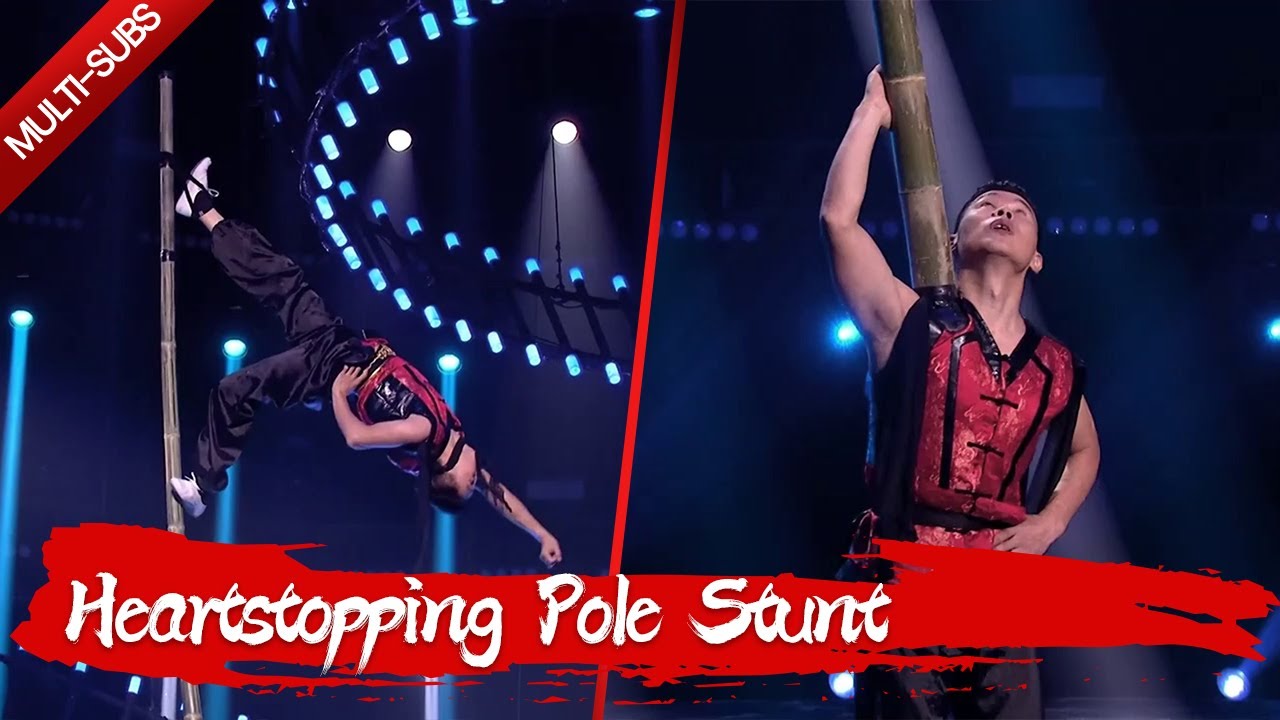 Acrobat shows dangerous moves on top of tall pole placed on the other's ...