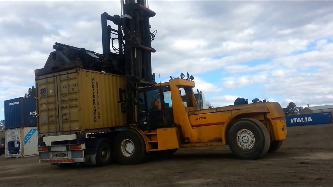 Hyster H32.00C with 20' shipping container loading truck from stack ...