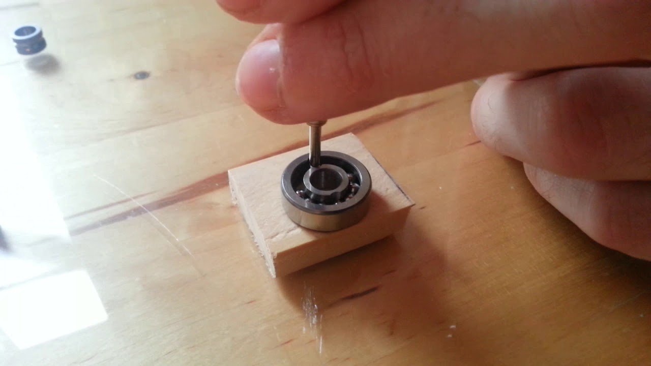 Inserting a ball in a DIY full complement bearing - YouTube