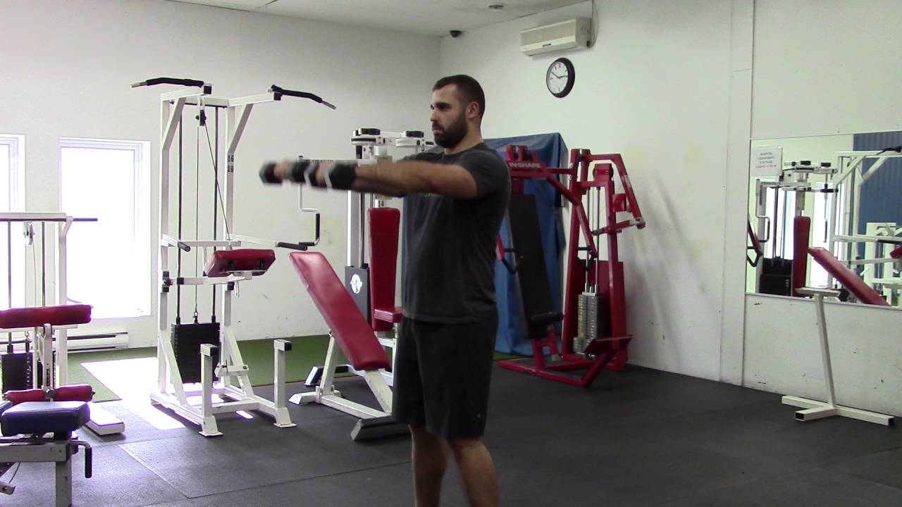 Élévation frontale de l'épaule avec haltères courts en position debout ...