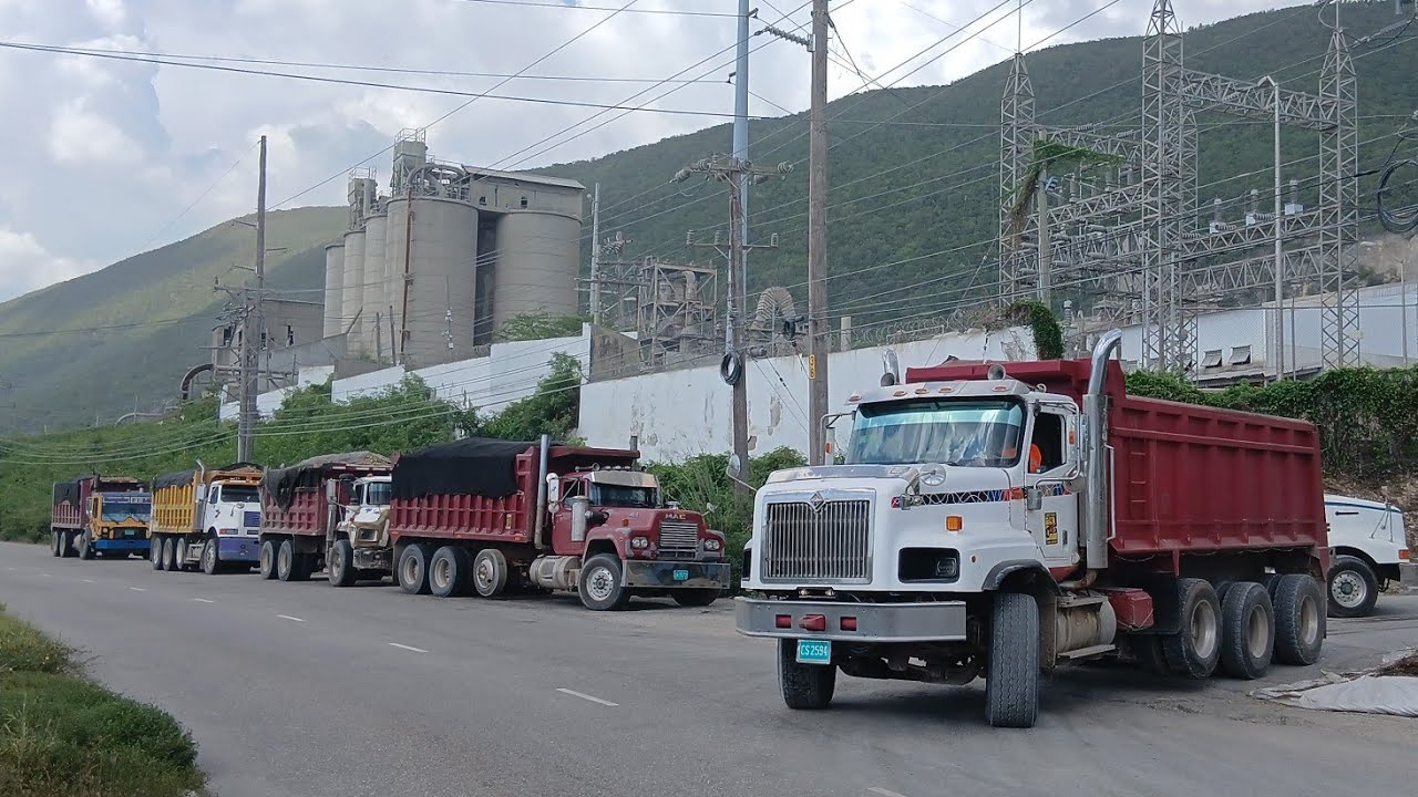 Trucks offloading tons of materials @caribcement - YouTube