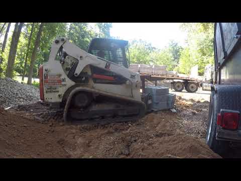 Bobcat and excavator grading, retaining wall installation and paver ...