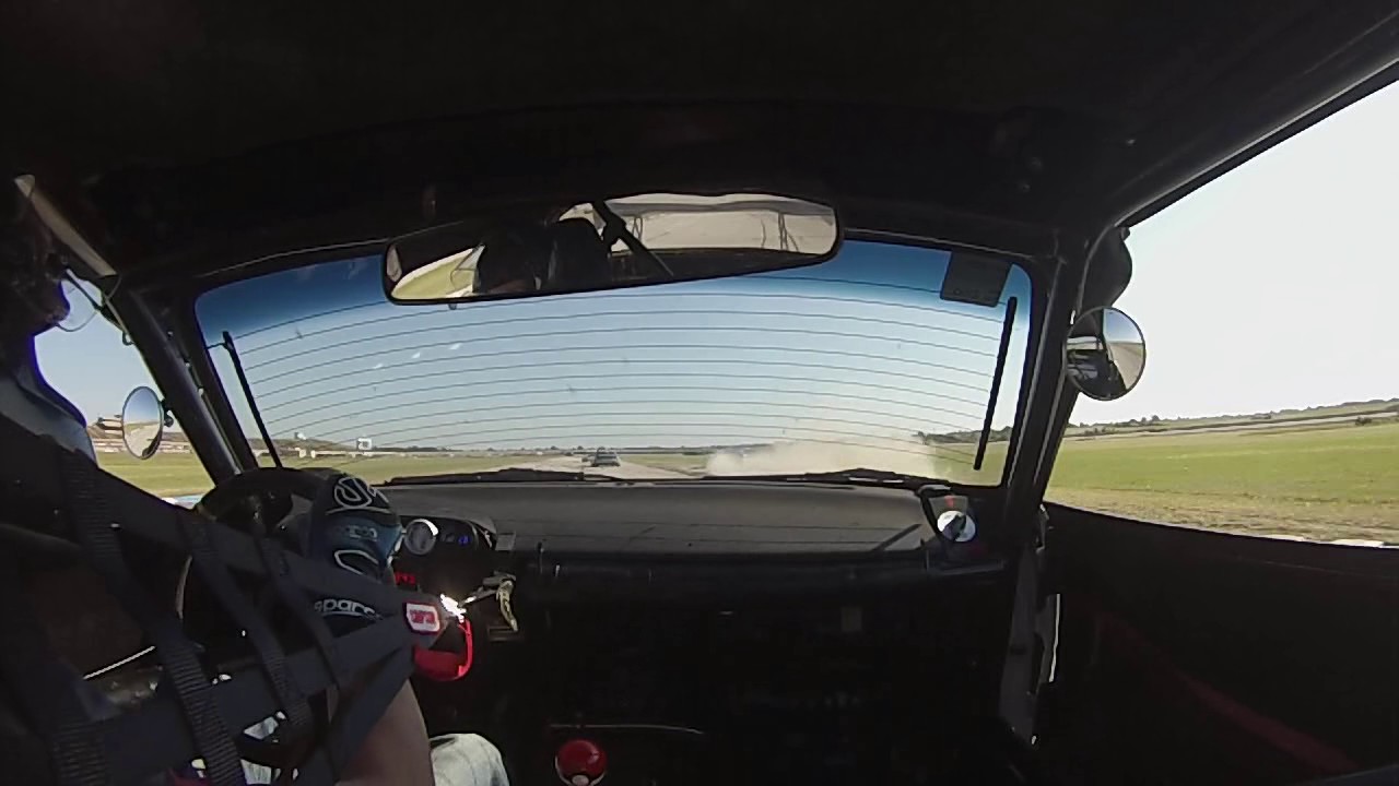 Rock smashes into race car window - YouTube