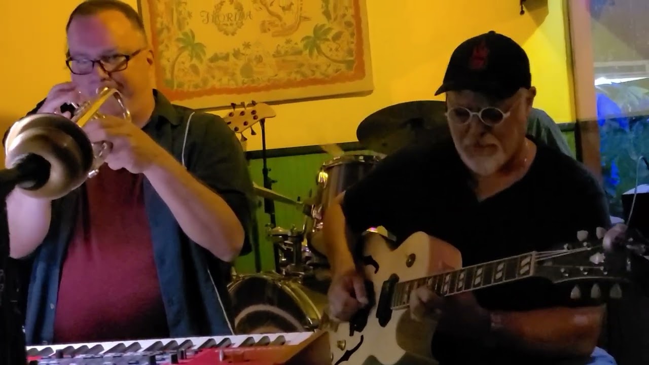 Derek Sims on trumpet and keyboard, Carlos Tamati on guitar and John ...