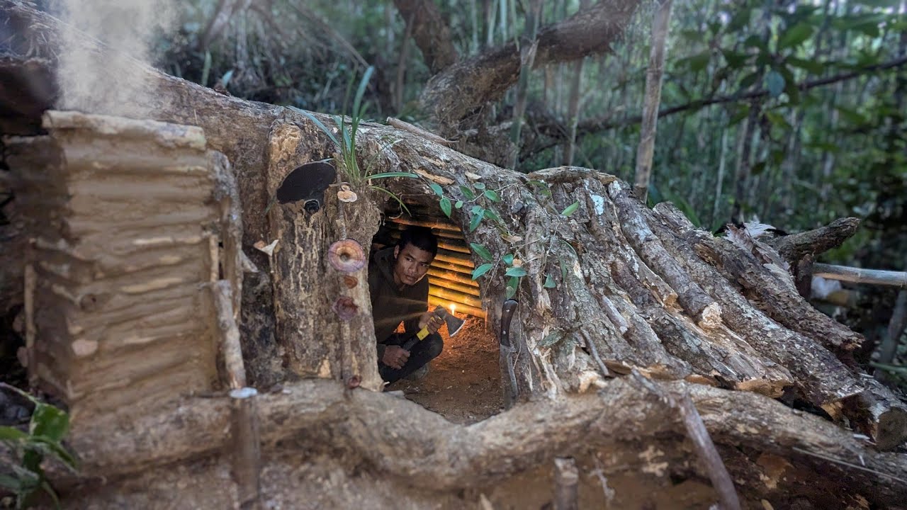 Building a secret dugout under a fallen tree , solo bushcraft camping ...
