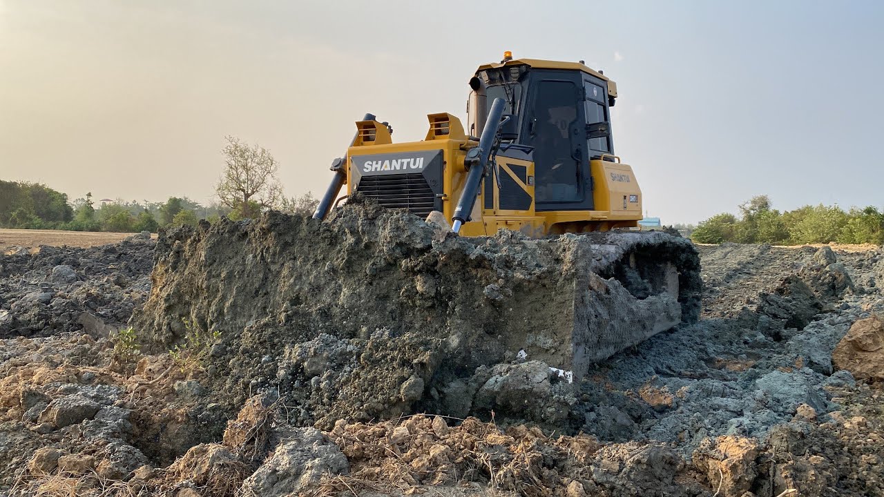Perfect talented skill operator bulldozer SHANTUI pushing muddy and ...