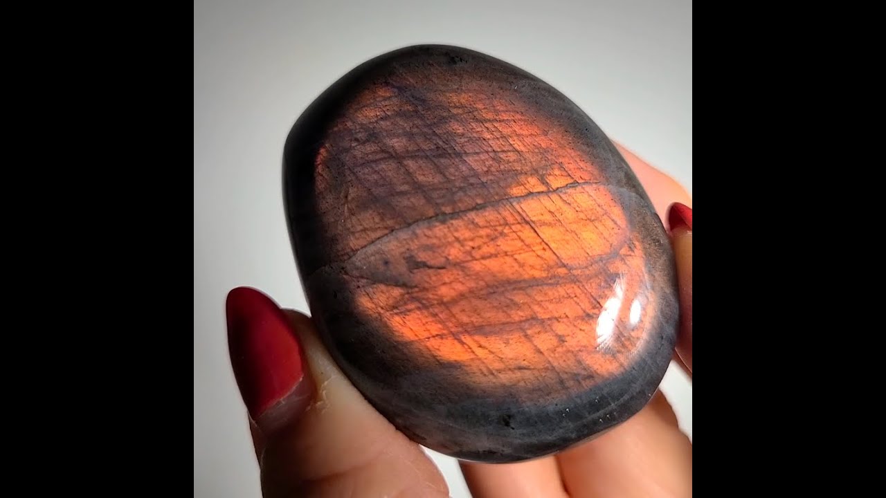 Orange flash labradorite palm stone with rainbows - YouTube