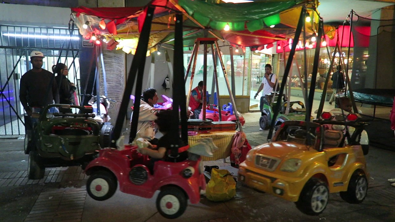 Hand powered merry-go-round in Bogota, Colombia - YouTube