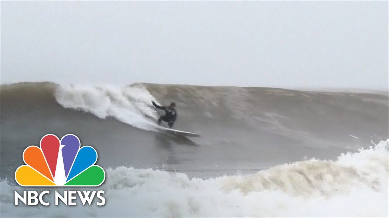 Surfers brave 33-degree Fahrenheit waters to catch waves on Lake ...