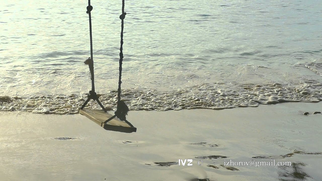 A rope swings on the beach, slow motion - YouTube