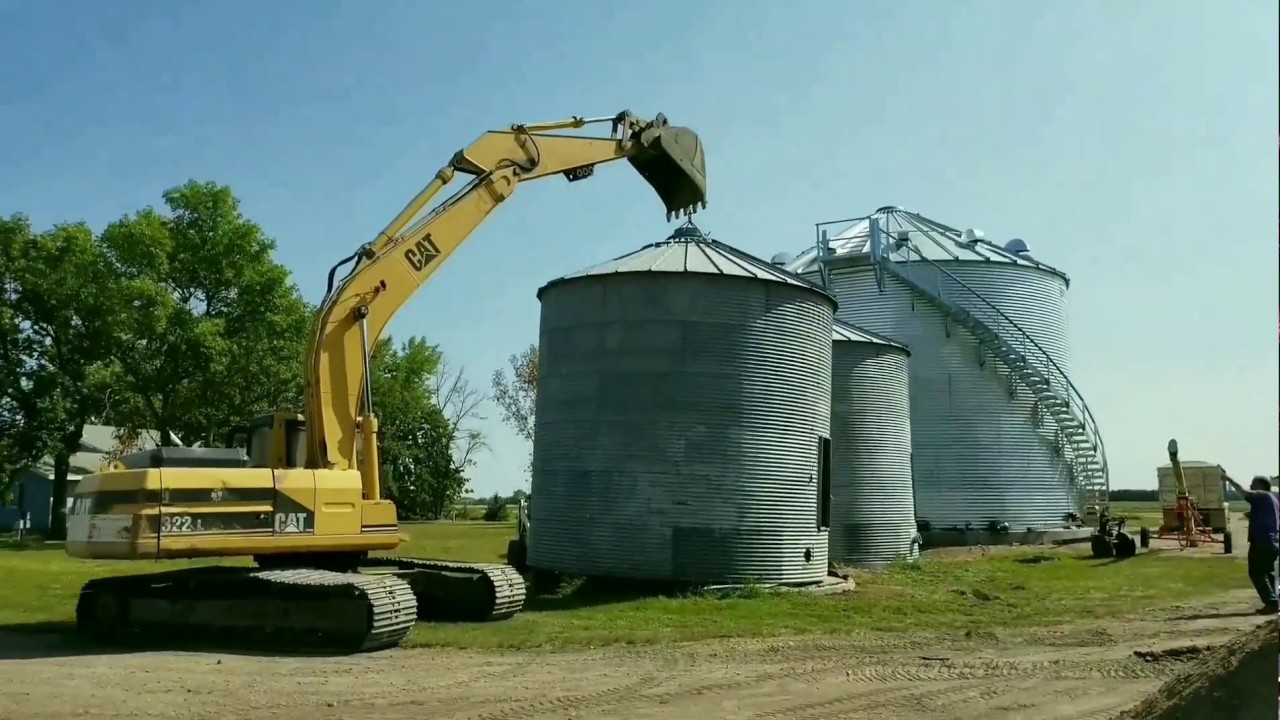 Moving grain bin with a backhoe, super cool! - YouTube