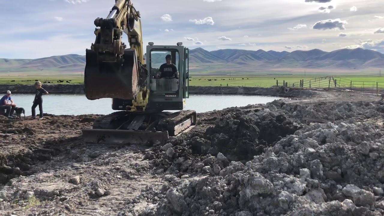Building up a culvert and the side of the little pond - YouTube