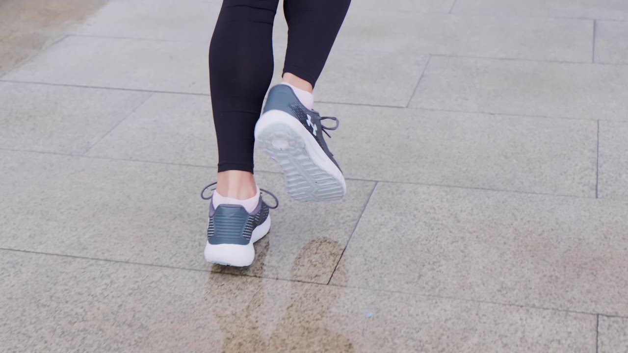 A Person Running On A Wet Concrete Pavement - YouTube