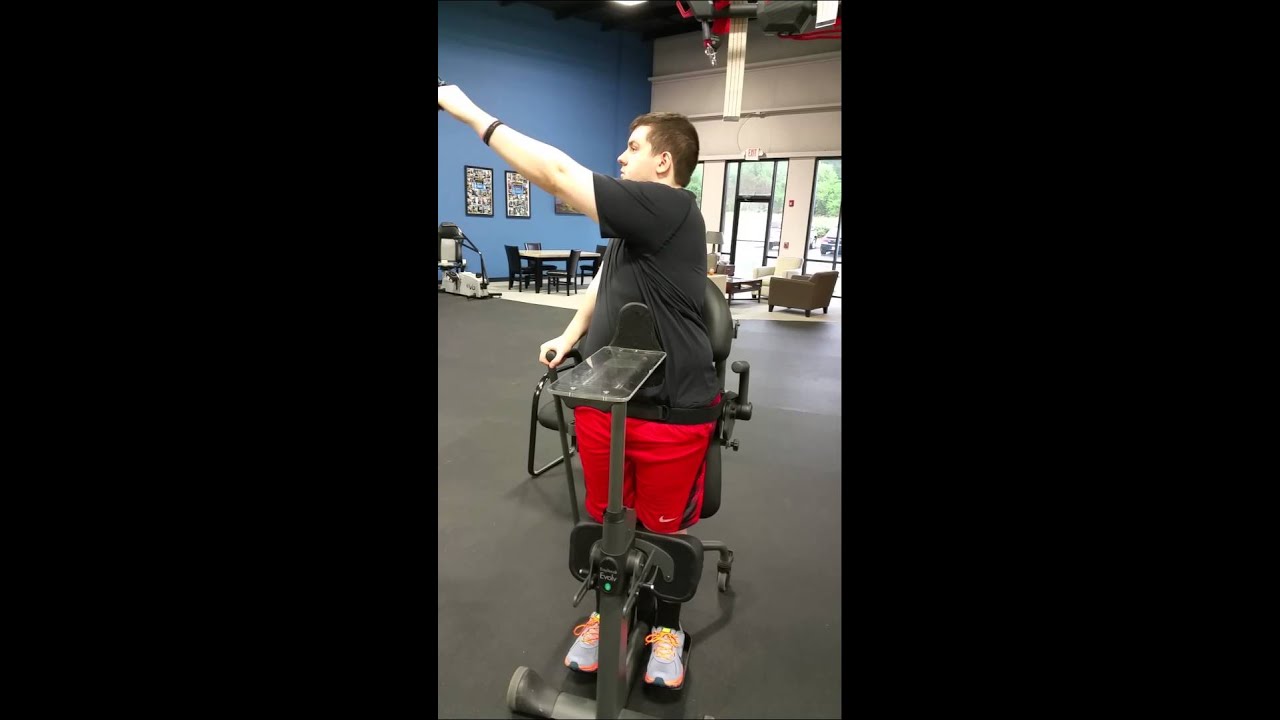Levi, T3 SCI, standing doing high cable cross body pulls engaging trunk ...