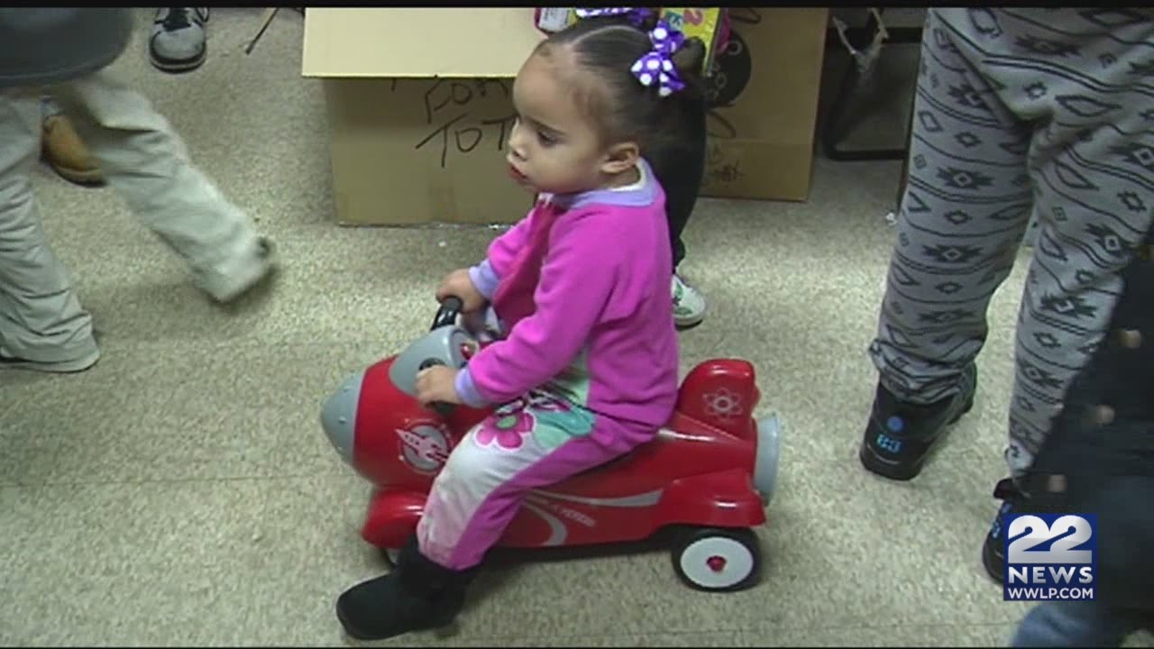 Hundreds of kids receive toys at HAPHousing center - YouTube