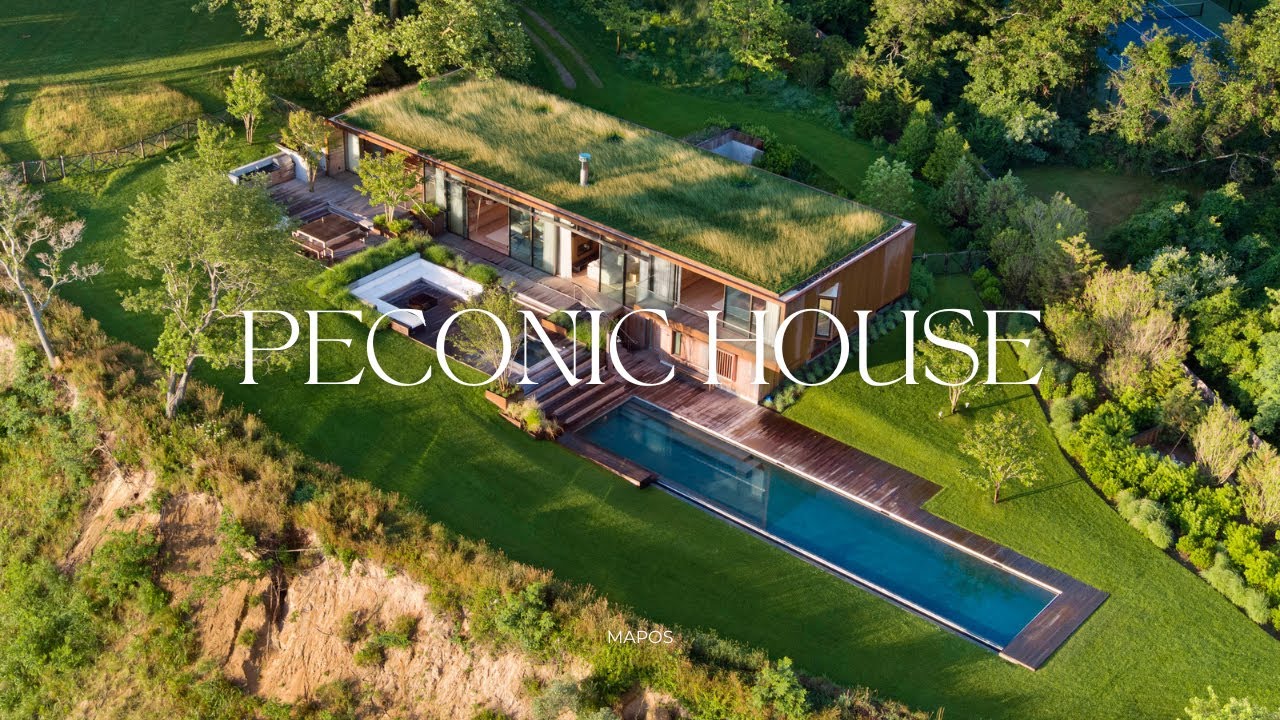 Modern House With Green Roof Nestled On Grass On A Lush Hill ...